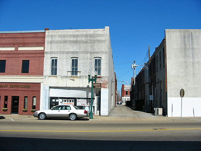 Paris's historic downtown square comes alive during market days, where locals gather under century-old shade trees for homemade treats and neighborly conversation. 