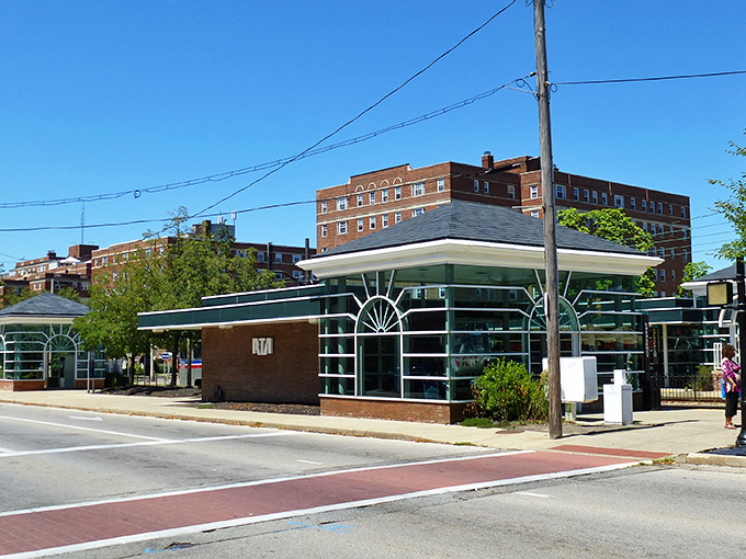 Tudor-style buildings line Cedar Fairmount district, where historic charm meets modern convenience. The bus shelter reminds you that car-free living is entirely possible here.