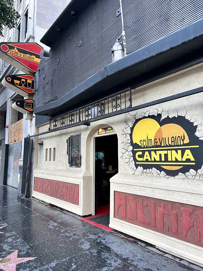 The unassuming exterior of Scum and Villainy Cantina beckons from Hollywood Boulevard, its cracked-wall logo promising adventure before you even step inside.