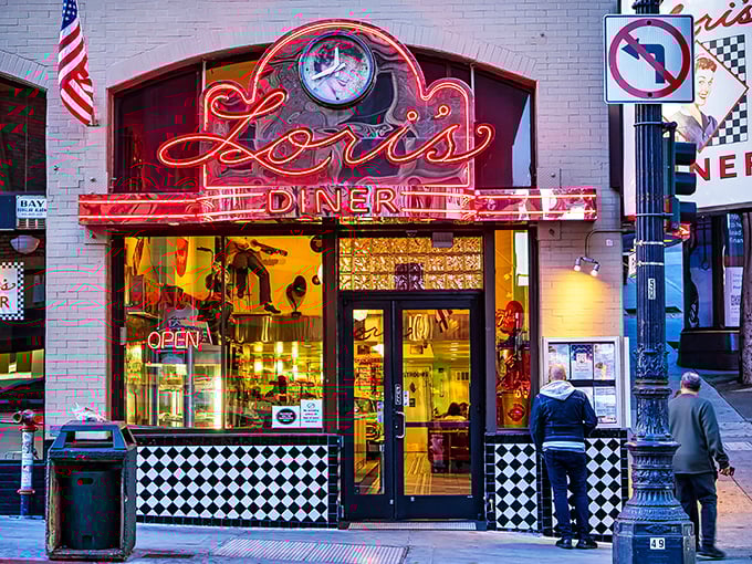 The neon glow of Lori's Diner beckons like a lighthouse for the hungry, promising a journey back to simpler, chrome-plated times.