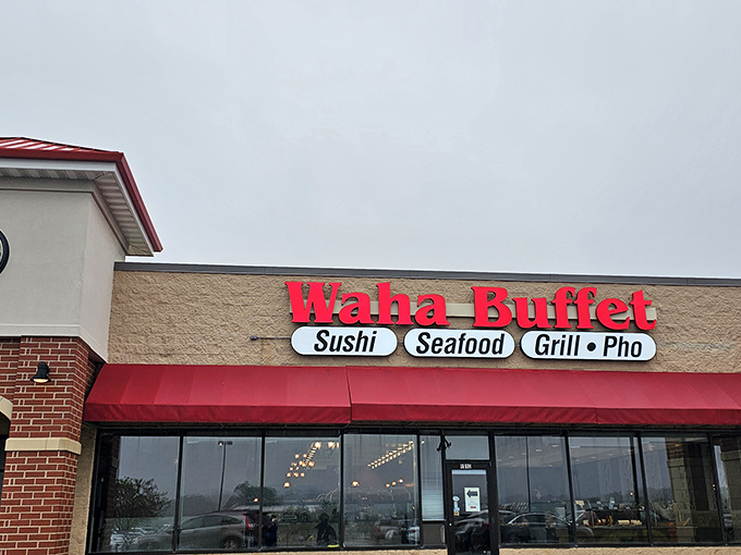 The bright red signage of Waha Buffet stands out like a culinary lighthouse, beckoning hungry travelers with promises of sushi, seafood, and pho paradise.