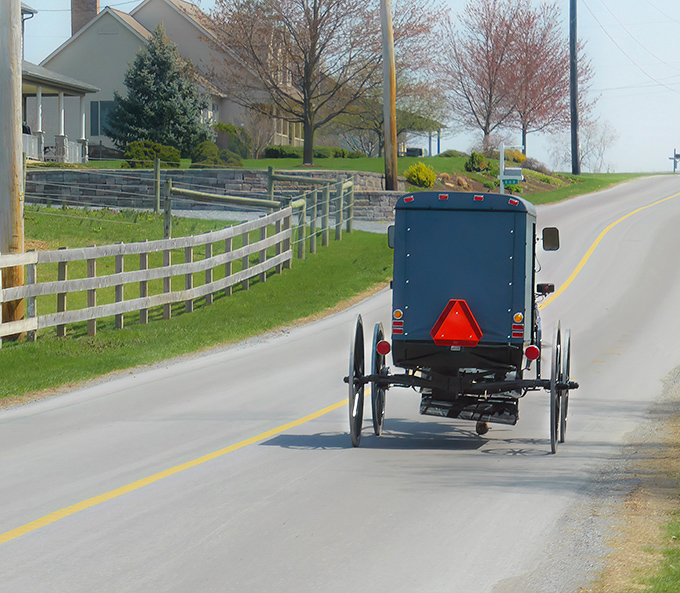 The classic Amish buggy against a church backdrop isn't just transportation&mdash;it's a moving postcard of a simpler time that somehow feels right at home in 2023.