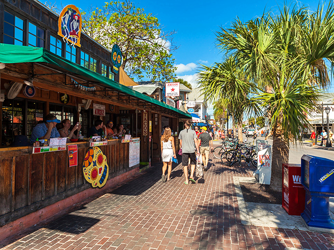 Colorful storefronts under swaying palms &mdash; the quintessential Keys experience where flip-flops are the dress code and relaxation is mandatory.