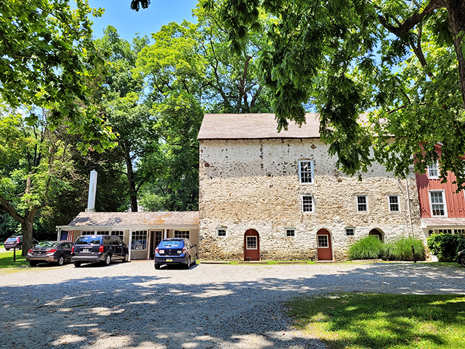 The historic stone facade of Baldwin's Book Barn stands proudly among the trees, like a literary fortress guarding centuries of stories within its walls. 