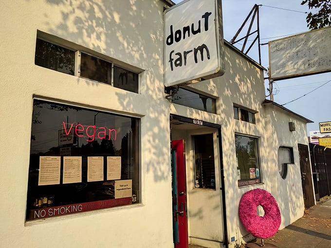 The unassuming exterior of Donut Farm, where Berkeley's vegan revolution quietly unfolds behind a simple sign and iron gate.