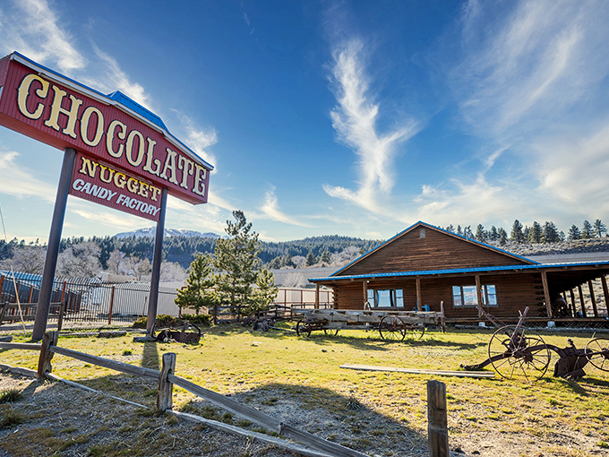 The rustic log cabin exterior of Chocolate Nugget beckons like a sweet mirage in the Nevada desert, complete with picnic tables for immediate sugar-rush recovery.