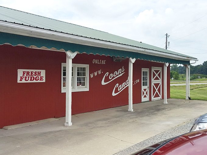 The iconic red exterior of Coons Candy beckons like a barn-sized treasure chest. Even the "FRESH FUDGE" sign seems to whisper sweet promises from across the parking lot.