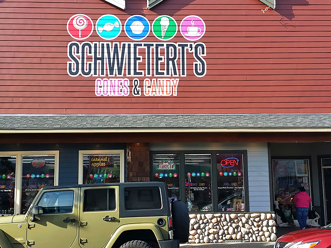 The burgundy facade of Schwietert's stands like a beacon of sweetness on Broadway Street, promising sugar-fueled adventures within those stone-trimmed walls.