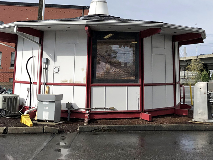 The iconic pink Almond Roca sign stands like a beacon of sweetness against the blue Tacoma sky, promising delicious treasures within.