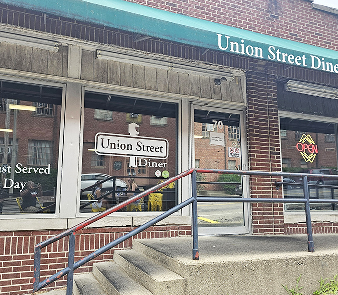 The unassuming brick exterior with its signature green awning promises comfort food magic within. Athens' hidden breakfast gem awaits.