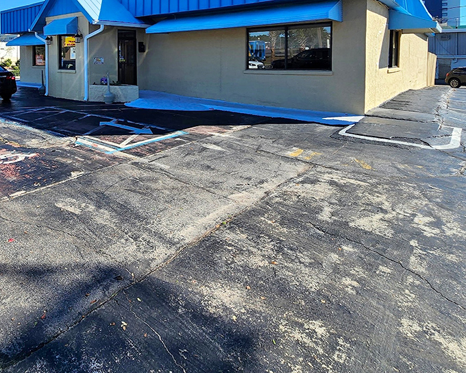 The iconic blue roof and yellow awnings of Harry's stand like a breakfast lighthouse, guiding hungry souls to pancake paradise.