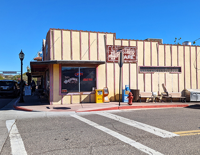 The yellow and red facade of Horseshoe Cafe stands like a beacon of breakfast hope on Wickenburg's main street, promising culinary comfort within those Western-themed walls.