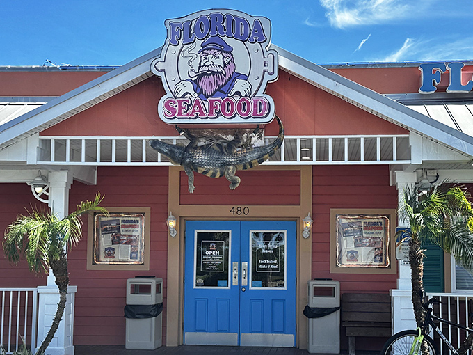 The coral-colored exterior with bright blue doors isn't just eye-catching&mdash;it's practically shouting "Fresh seafood inside!" like a friendly maritime beacon.
