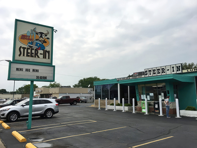 The iconic turquoise exterior of Steer-In beckons hungry travelers like a culinary lighthouse on Indianapolis's east side. That cartoon steer in a chef's hat knows what's up.
