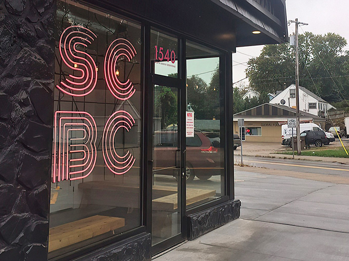 That neon pink SCBC sign glows like a breakfast beacon, promising morning salvation to hungry Omahans seeking refuge from ordinary eggs. 