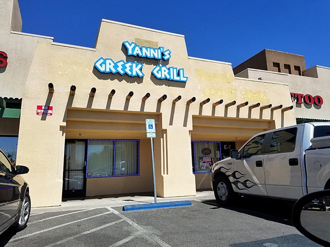 The unassuming exterior of Yanni's Greek Grill stands like a Mediterranean mirage in the Las Vegas desert, promising authentic flavors behind its blue signage.