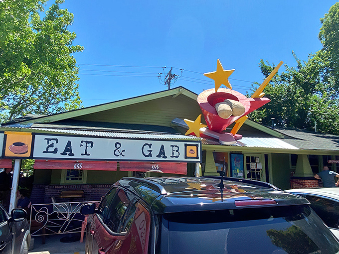 The giant red coffee cup sculpture stands like a caffeinated sentinel, welcoming hungry visitors to this quirky vegetarian oasis in Oklahoma City.
