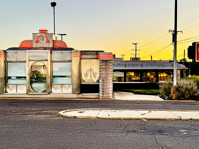 Gleaming in the sunset glow, The Dining Car's classic stainless steel exterior promises a time-traveling culinary adventure that begins before you even step inside.