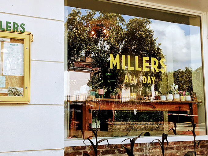 A glimpse of paradise through paned windows—Millers All Day's inviting exterior promises breakfast bliss behind that cheerful yellow door.
