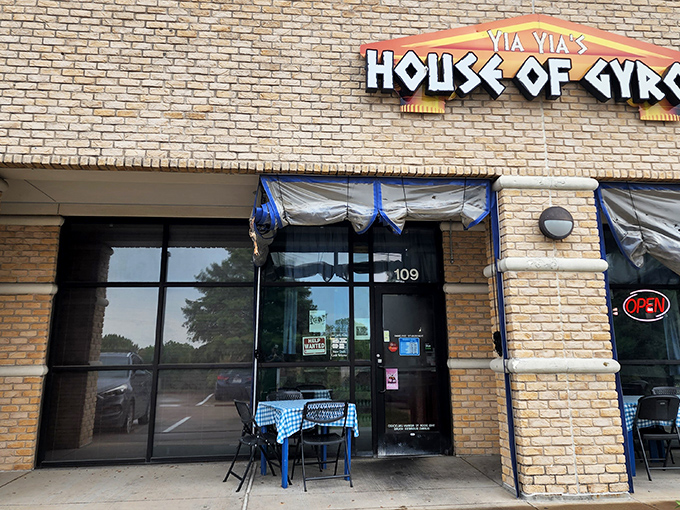 The glowing sign of Yia Yia's House of Gyros beckons like a Mediterranean lighthouse in a sea of Texas strip malls. Greek paradise awaits inside!