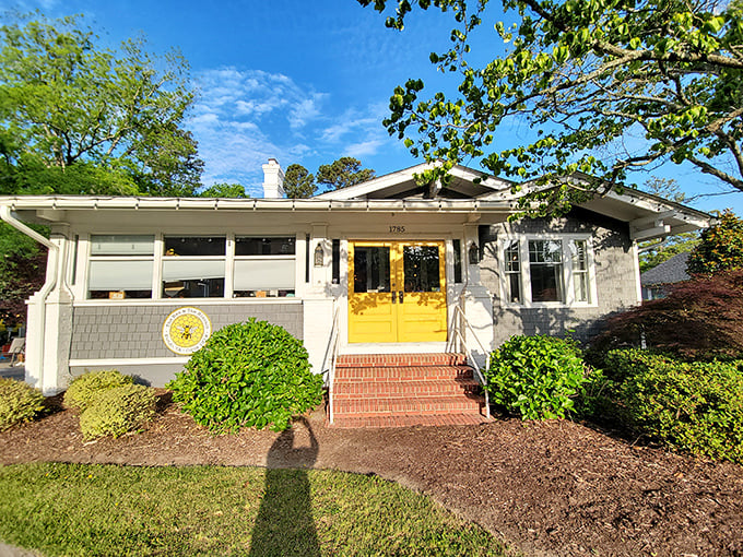 Those sunny yellow doors aren't just welcoming you to breakfast&mdash;they're practically daring you not to smile. Cottage charm with a side of morning promise.