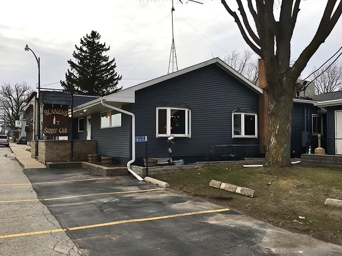 The unassuming blue exterior of Blanck's Supper Club in Malone, where culinary magic happens without fancy pretense or big-city fanfare.