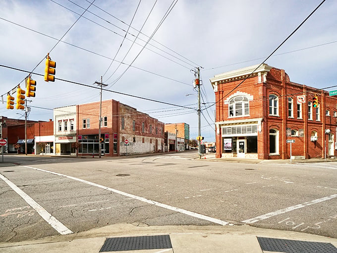 Historic brick buildings stand sentinel at this downtown intersection, where time seems to move at its own comfortable pace.