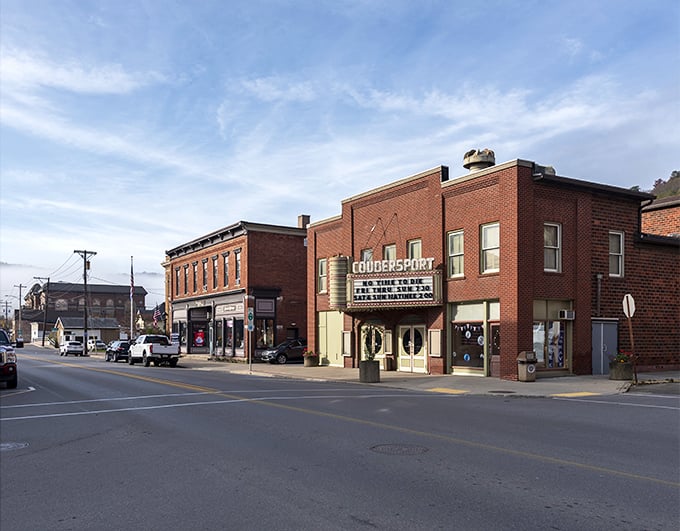 Main Street Coudersport in autumn glory &ndash; where brick buildings stand like sentinels against a backdrop of hills ablaze with fall foliage. Small-town America at its most photogenic. 