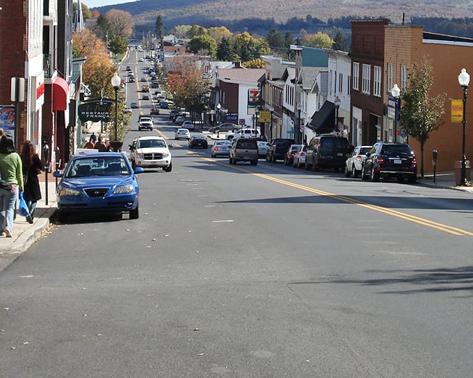 Main Street stretches before you like a Norman Rockwell painting come to life, where traffic jams involve three cars and everyone waves.