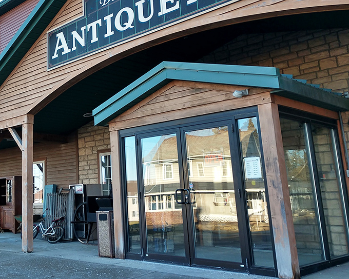 The unassuming exterior of Berlin Village Antique Mall beckons like a time portal disguised as a country store. Wooden charm with a promise of treasures within.