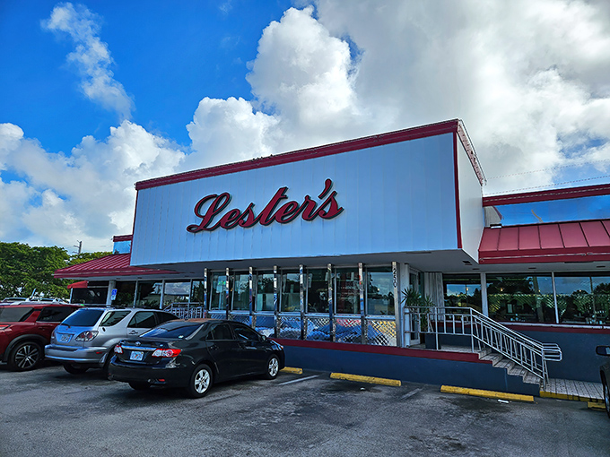 The iconic red and white exterior of Lester's Diner stands like a time capsule of Americana, beckoning hungry travelers with promises of comfort food paradise.