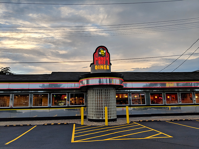 The iconic yellow and black Honey Bee Diner sign stands like a beacon of breakfast hope along Ritchie Highway, promising comfort food salvation to hungry travelers.