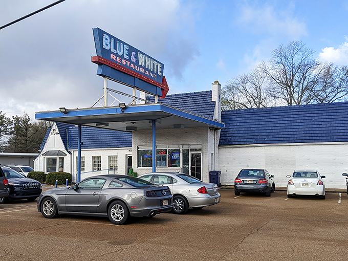 The iconic Blue & White Restaurant stands as a time capsule of Americana, its vintage gas station canopy beckoning hungry travelers along Highway 61.