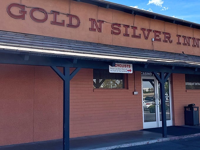 The iconic orange exterior with glowing red signage announces itself like Vegas neon for the hungry. No pretension, just breakfast promise.