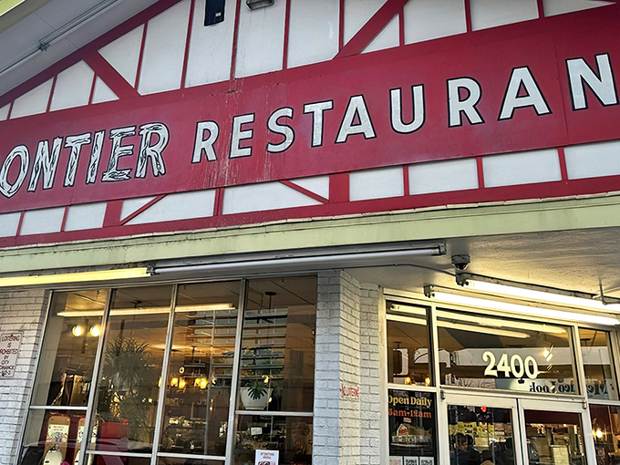 The iconic white and red exterior of Frontier Restaurant stands like a beacon of breakfast hope on Central Avenue, drawing hungry pilgrims daily.