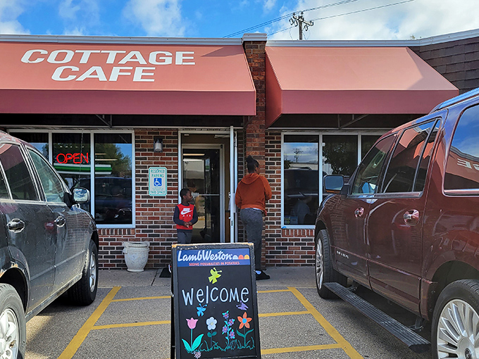 The coral-colored awnings of Cottage Cafe stand like beacons of breakfast hope against Madison's skyline, promising comfort food salvation to hungry travelers.