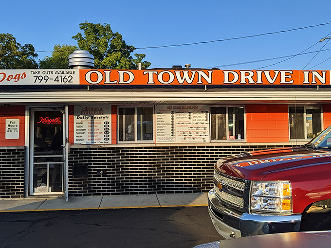 The bright orange facade of Old Town Drive-In stands as a beacon of burger bliss in Saginaw, promising nostalgic flavors that modern fast food chains can only dream of replicating.