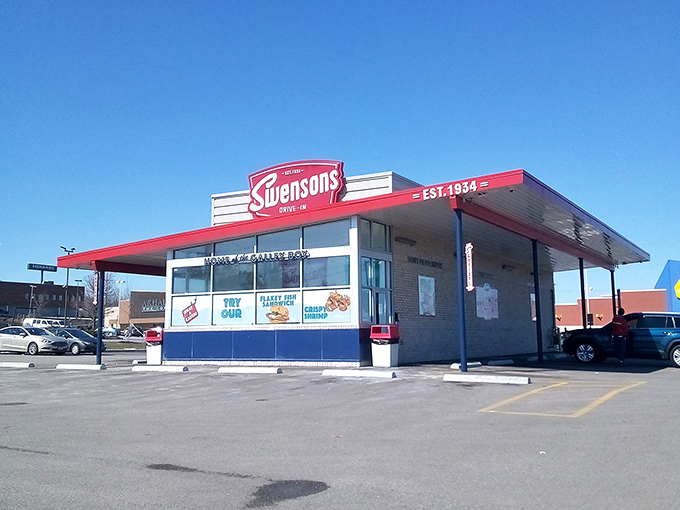The iconic red and white Swensons facade stands proudly against an Ohio sky, promising burger bliss to all who flash their headlights.