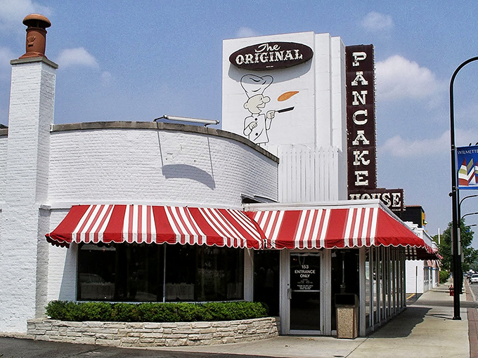 The iconic white building with red-and-white awnings stands like a breakfast beacon, calling hungry pilgrims from across Illinois to pancake paradise.