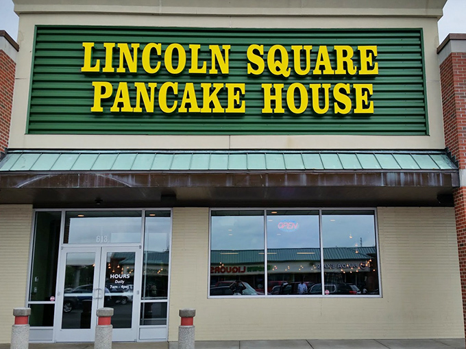 The iconic green and yellow sign beckons hungry travelers like a breakfast lighthouse guiding morning-starved sailors to pancake paradise.