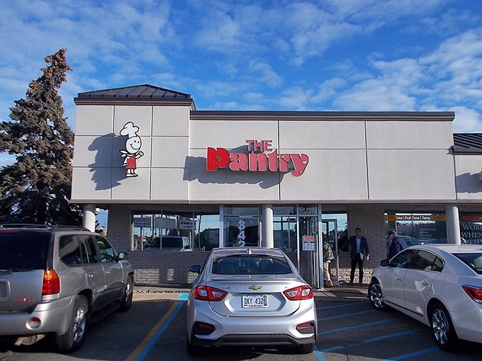The unassuming exterior of The Pantry Restaurant, where breakfast dreams come true and parking spots are worth their weight in maple syrup.