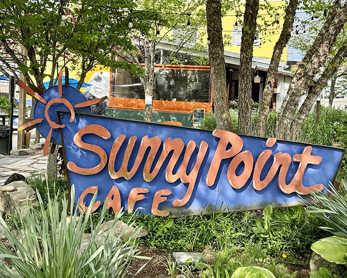 The iconic blue sign says it all – people aren't just waiting for breakfast, they're queuing for a culinary pilgrimage at Sunny Point Café.