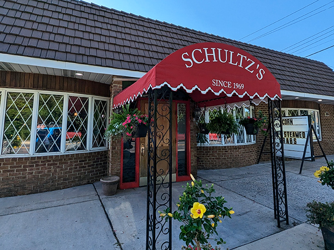 The iconic red awning of Schultz's welcomes seafood pilgrims like a lighthouse guiding hungry sailors home. A Maryland institution since 1969