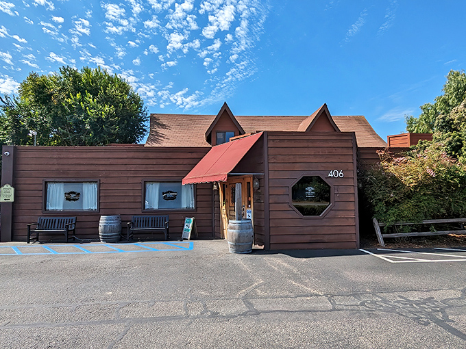 The iconic red awning and rustic wooden entrance of The Hitching Post II welcomes hungry travelers like a beacon of hope for carnivores on the highway.