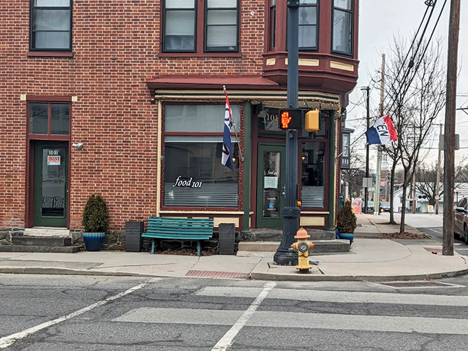 The welcoming entrance to Kitchen 101 feels like a secret doorway to sandwich paradise, complete with charming flower pots and historic brick fa&ccedil;ade.