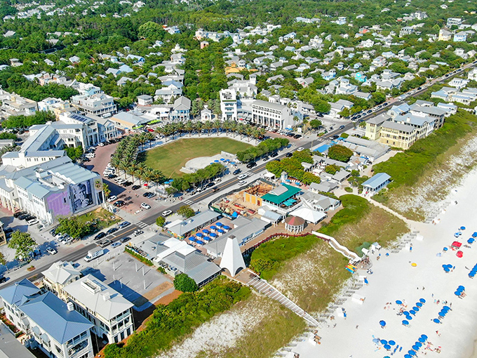 Aerial perfection: Seaside's master-planned paradise unfolds like a storybook from above, where emerald waters meet pristine white beaches and pastel-colored cottages create a living watercolor.