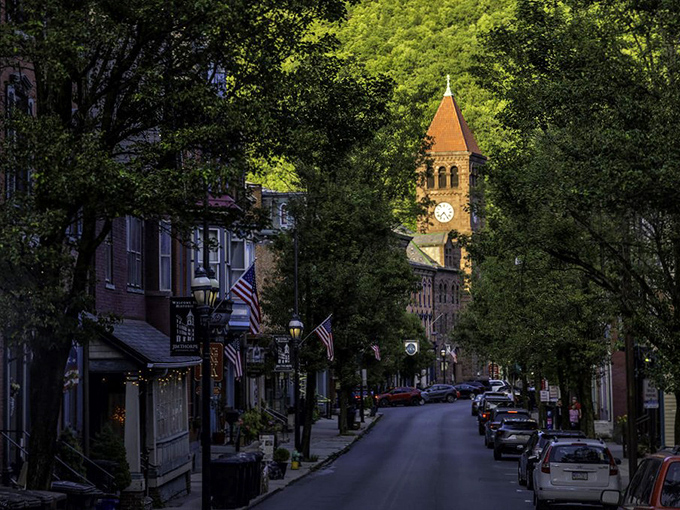 Broadway beckons with its rainbow of Victorian facades, where the clock tower stands sentinel over a street that time politely decided to respect.