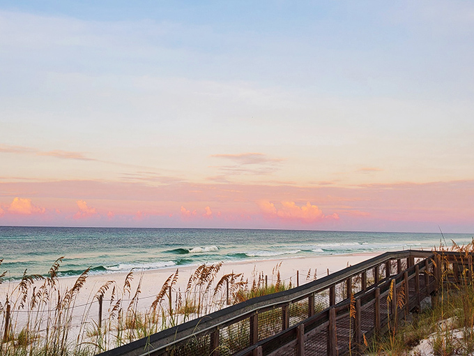 Nature's own masterpiece: where cotton candy skies meet emerald waters along a wooden boardwalk that practically begs you to kick off your shoes.