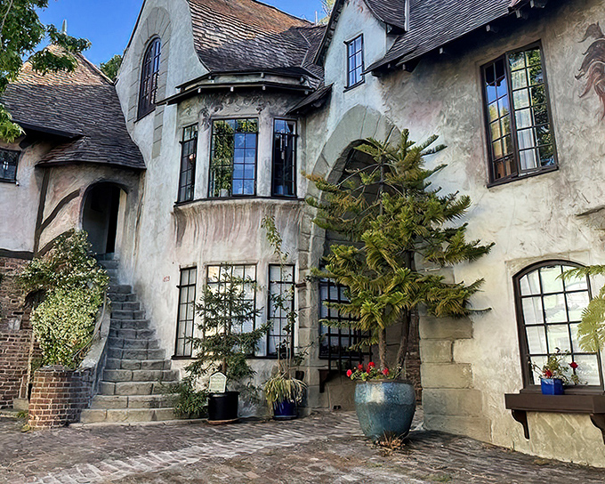 Stone archways and weathered walls create an entrance that would make medieval architects weep with envy. 