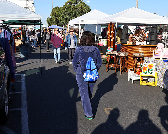 Treasure hunters navigate the sea of white tents, carts at the ready. The thrill of the hunt is palpable under the California sun.
